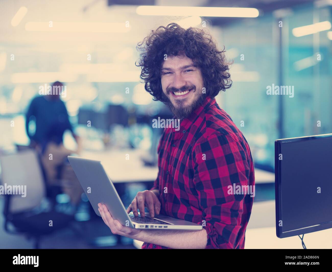 smiling male software developer using laptop Stock Photo - Alamy