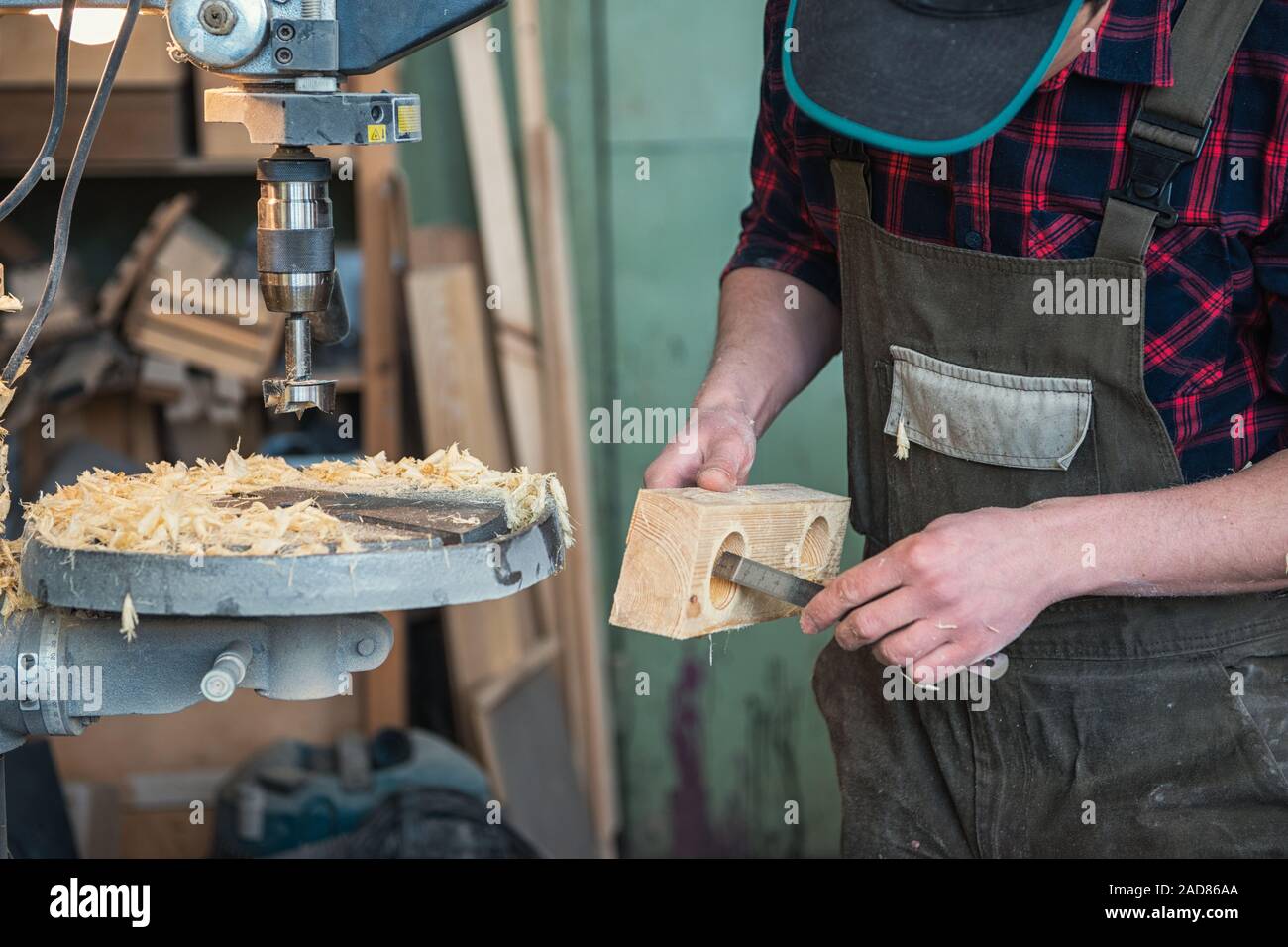 Carpenters with electric drill machine drilling wooden board Stock ...