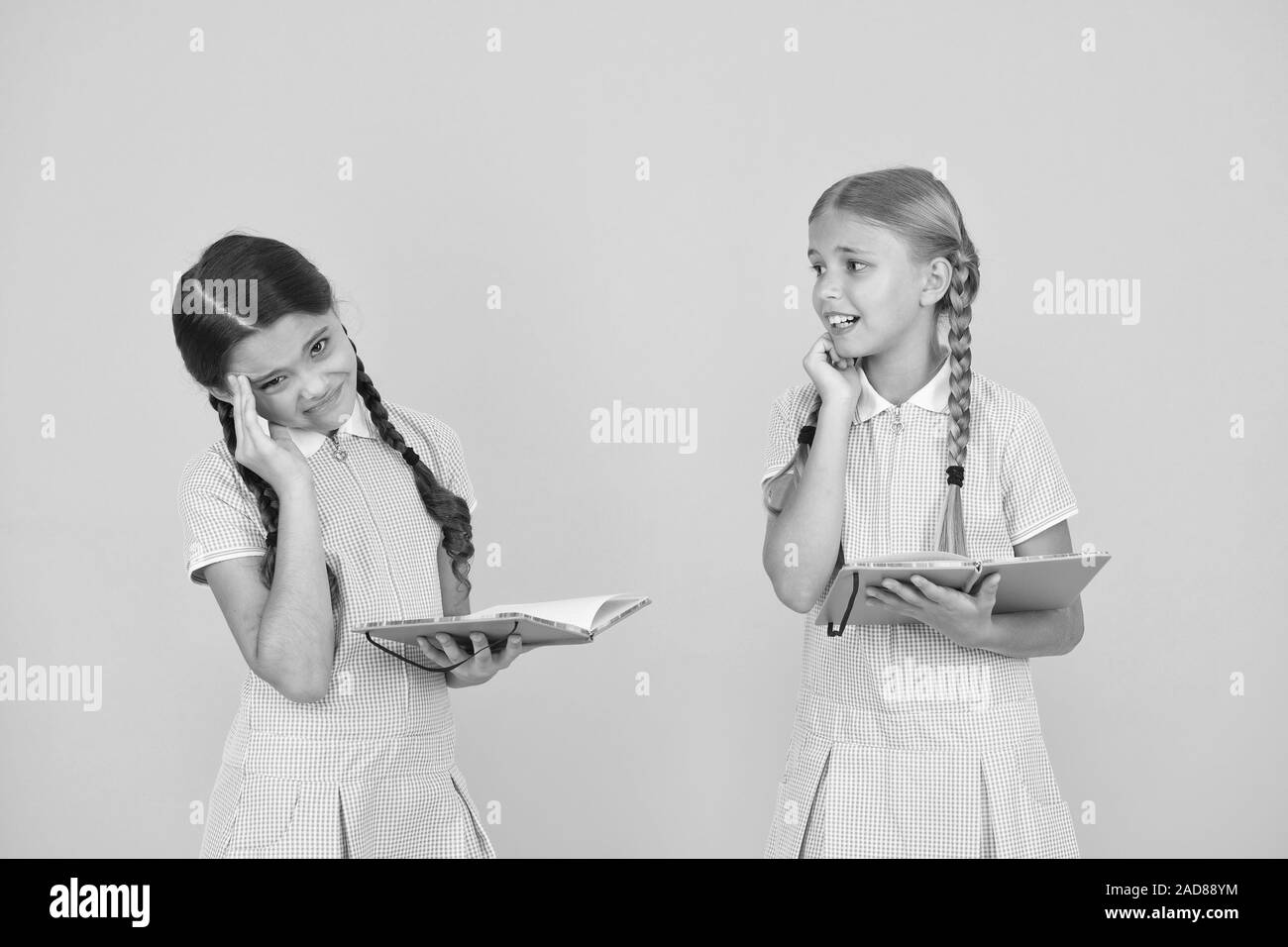 Nervous kids. Cute children reading book on yellow background. Adorable ...