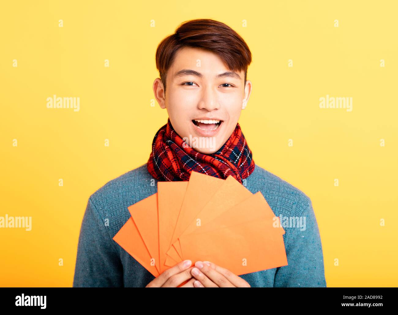 happy asian young man celebrating chinese new year Stock Photo - Alamy