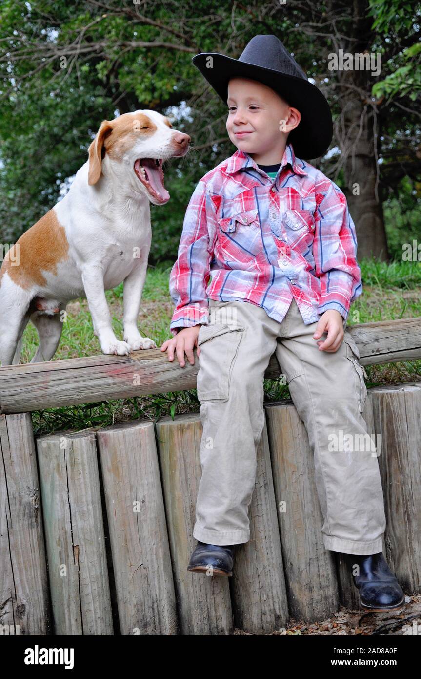 Boy wearing cowboy hat and boots with pet dog Beagle Stock Photo - Alamy