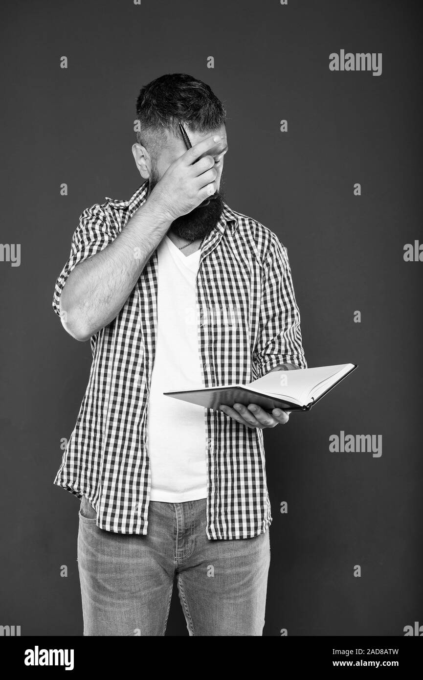 Keep reading, knowledge is power. Bearded man reading book on grey ...
