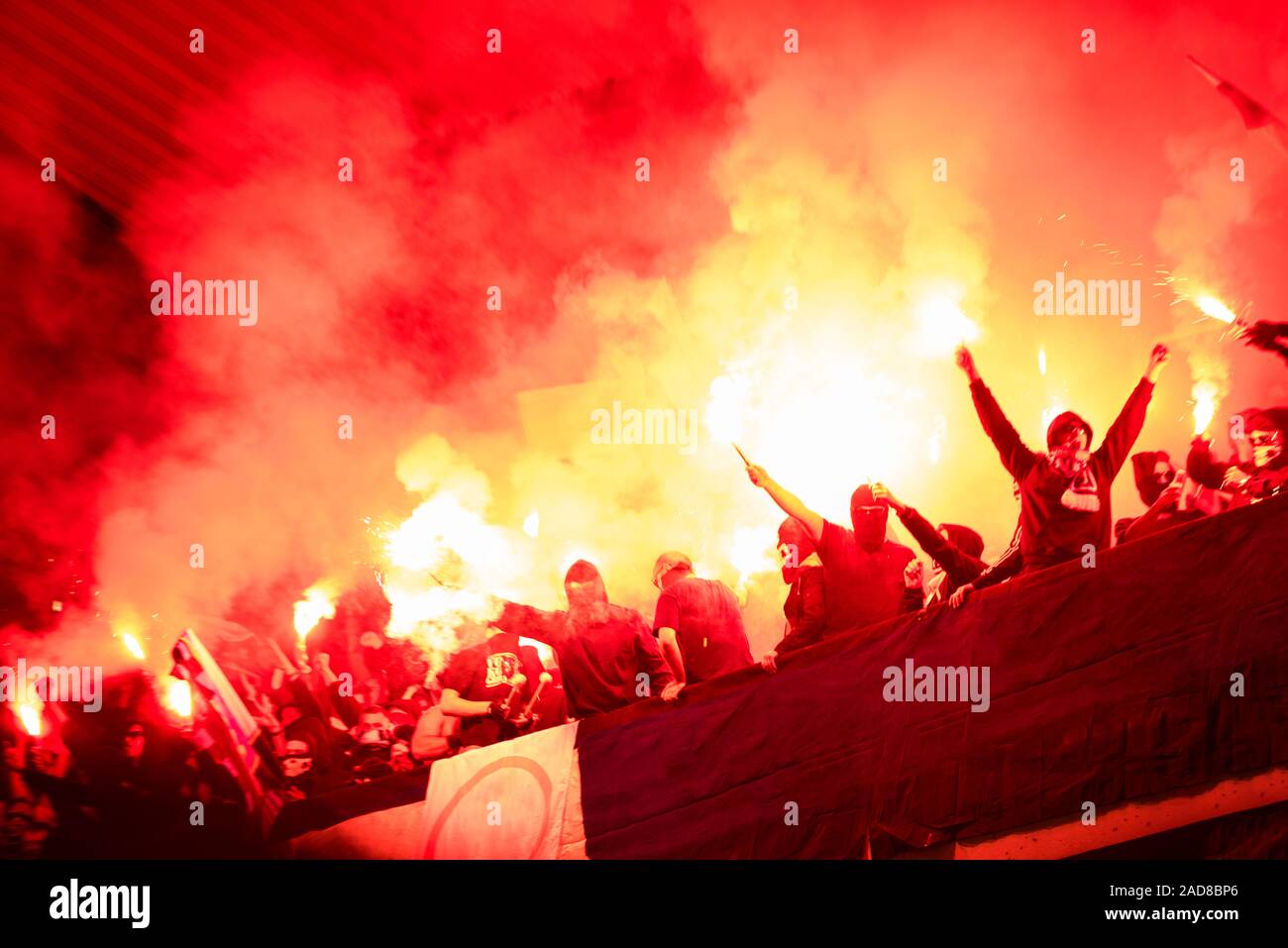 football hooligans with mask holding torches in fire Stock Photo - Alamy