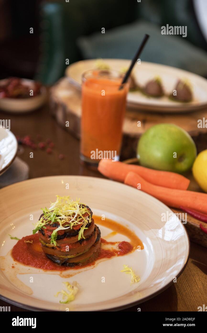 Baked vegetables in layers, fruits and carrot juice Stock Photo - Alamy