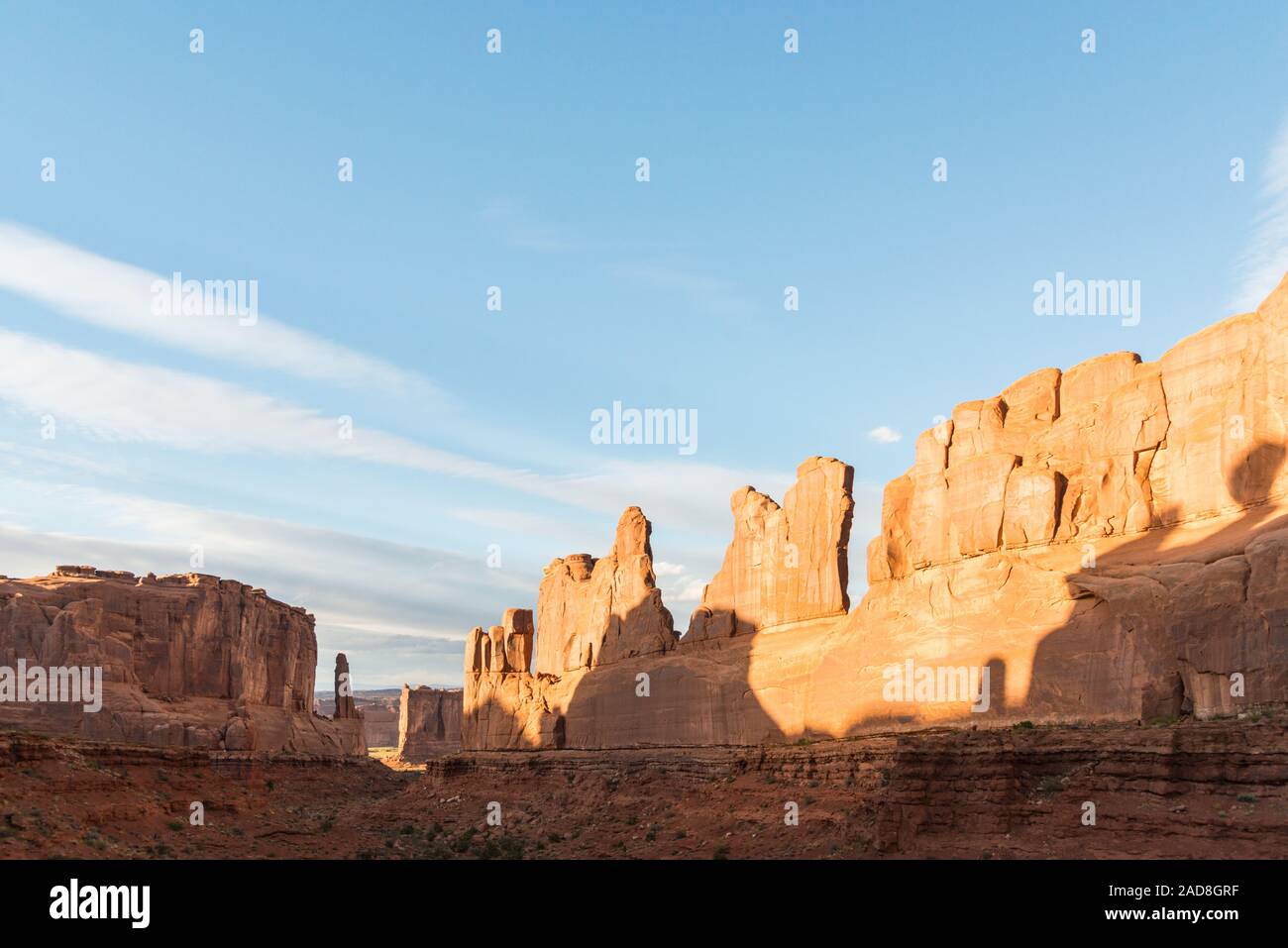 A wall made by rock formations with shadows and sunset lights. Arches ...