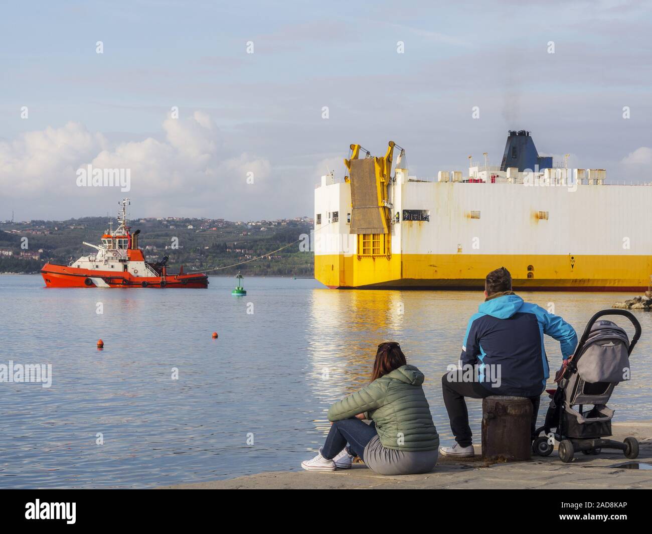 Container ship with tug boat at the port of Koper in Slovenia Stock ...