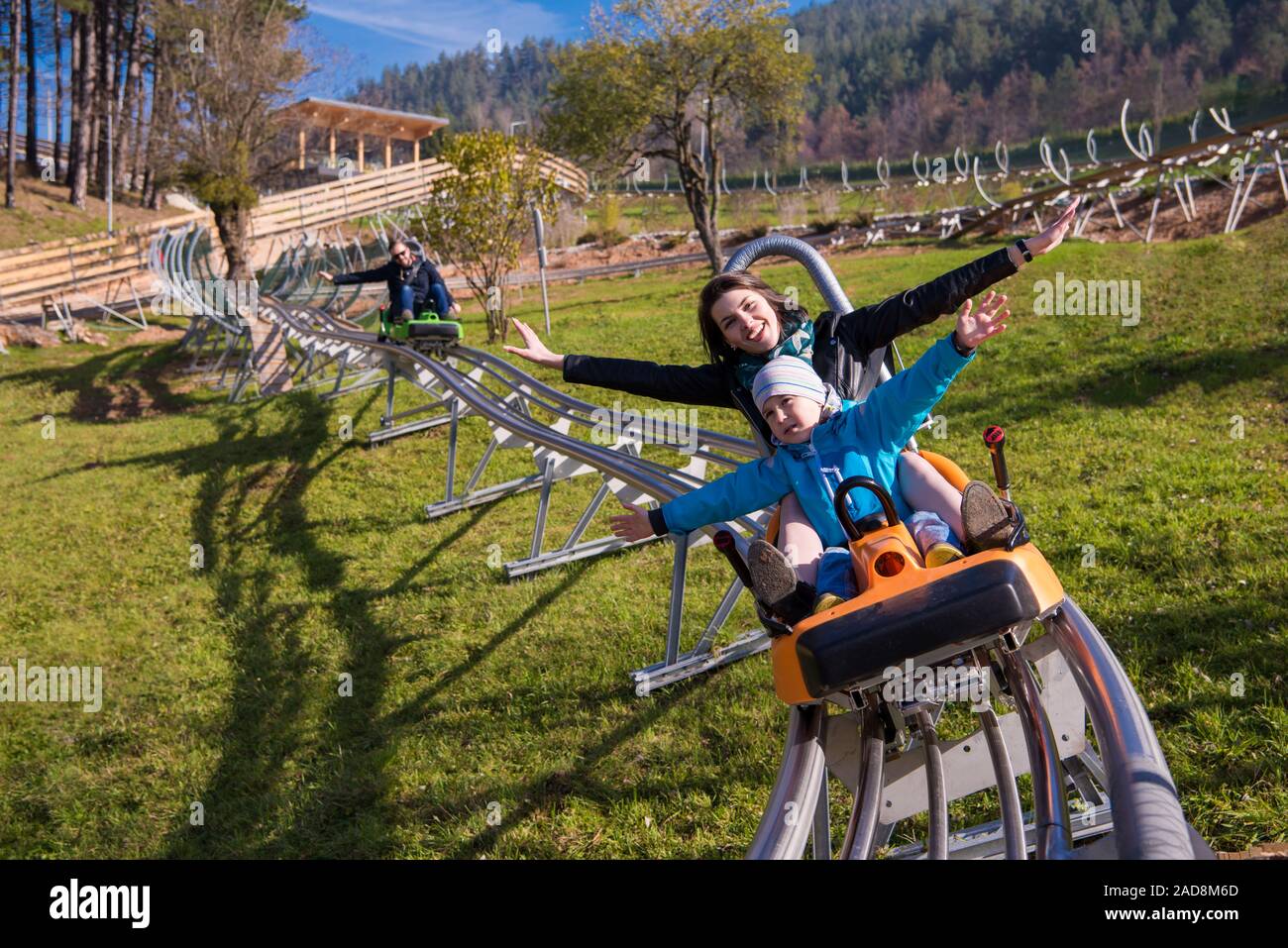 young mother and son driving alpine coaster Stock Photo - Alamy