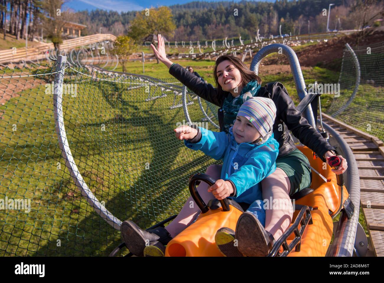 young mother and son driving alpine coaster Stock Photo - Alamy