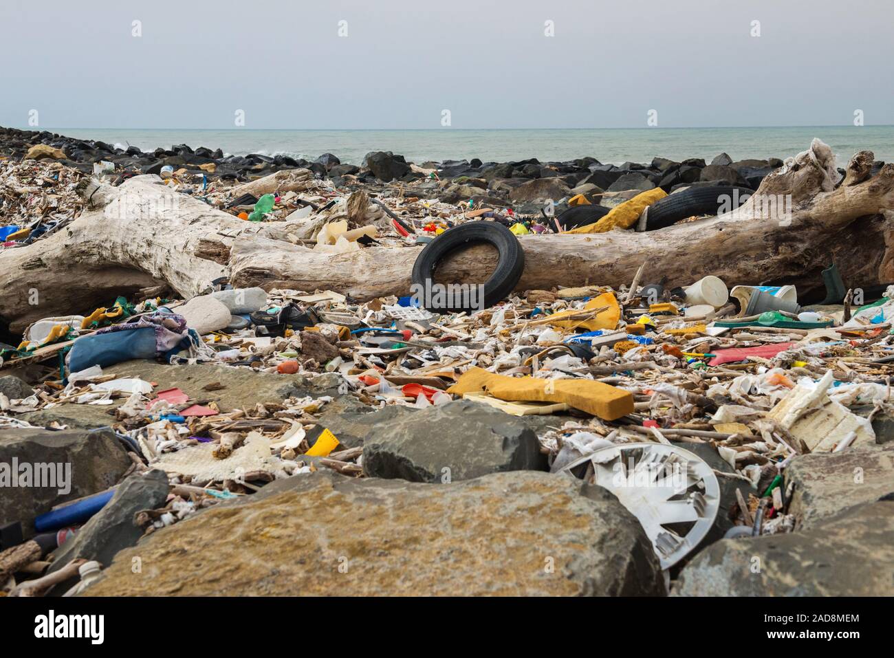 Spilled garbage on the beach near the big city. Empty used dirty ...