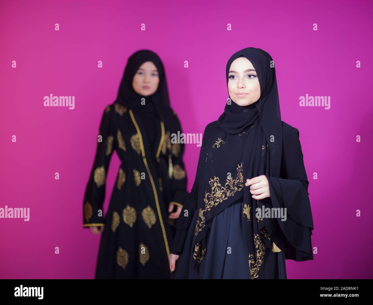 two hijab muslim woman on pink background Stock Photo - Alamy