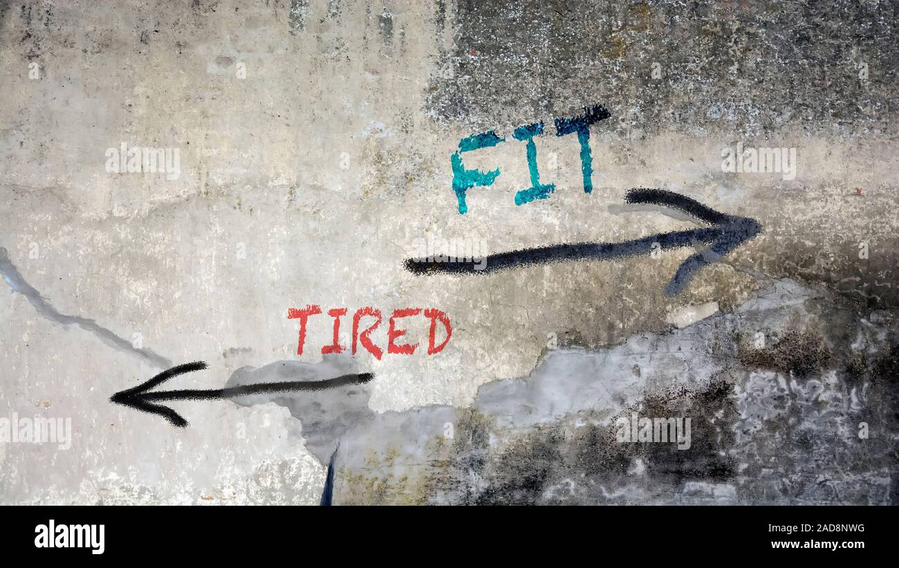 Wall Graffiti Fit versus Tired Stock Photo - Alamy
