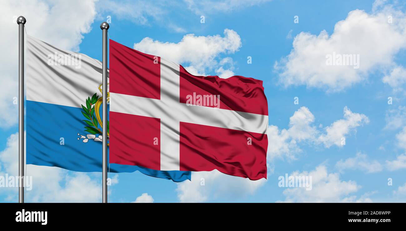 San Marino and Denmark flag waving in the wind against white cloudy ...