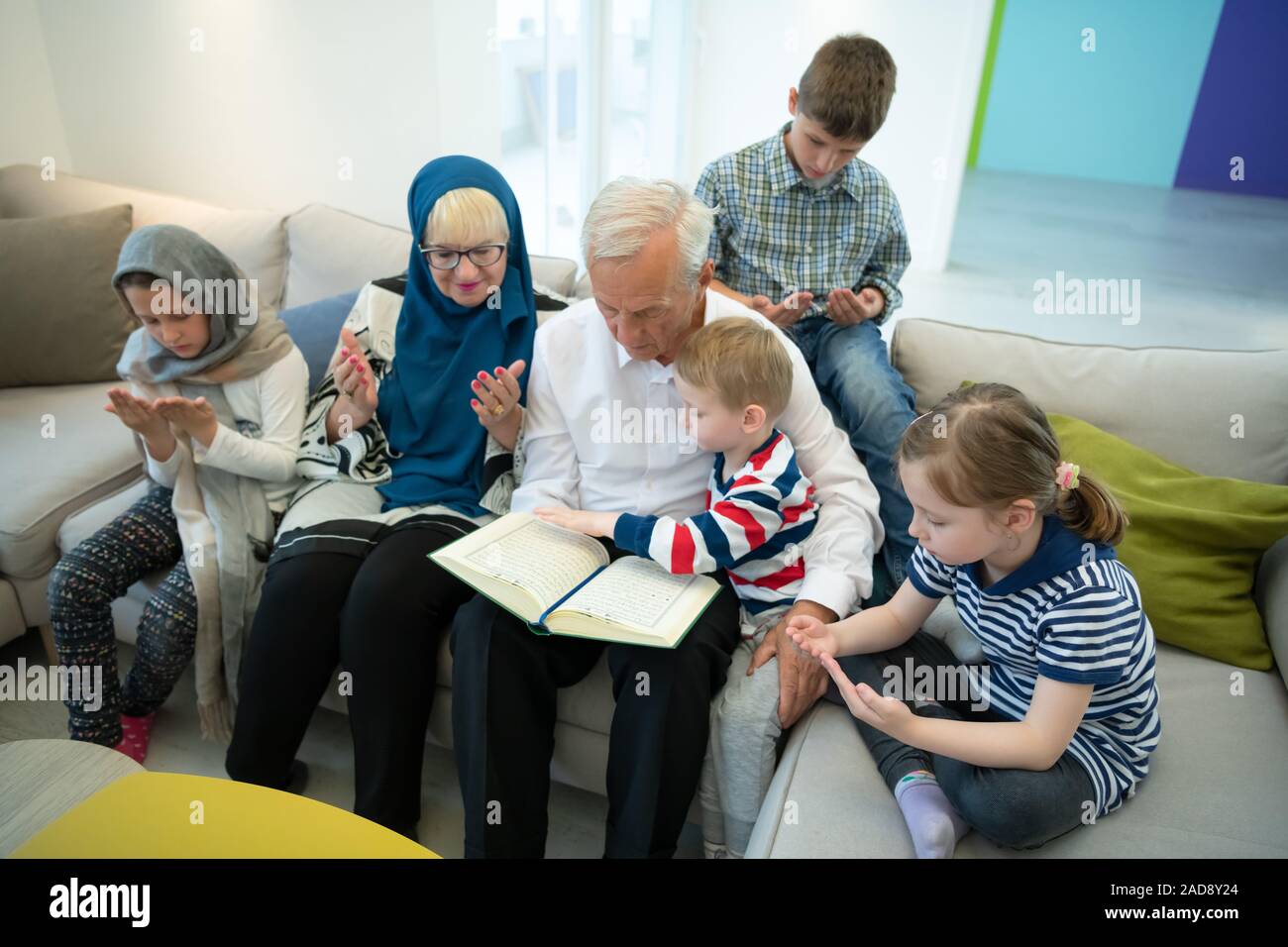 modern muslim grandparents with grandchildren reading Quran Stock Photo ...