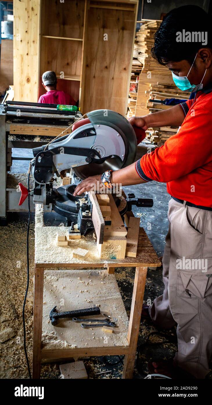 A carpenter cut the wood using machine in his workshop. the process of making furniture Stock Photo Alamy