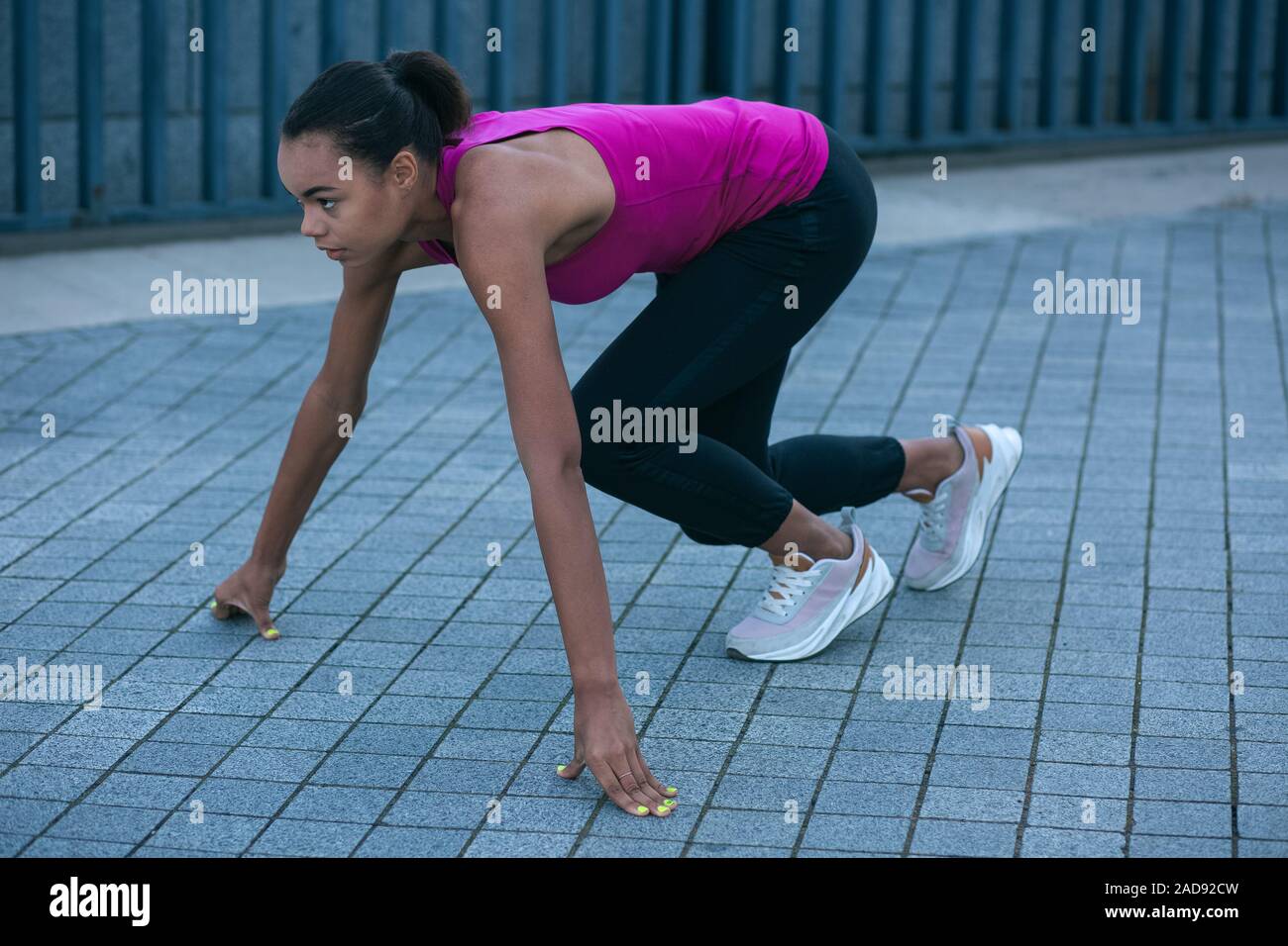 Hands and feet of runner on the ground stock photo Stock Photo - Alamy