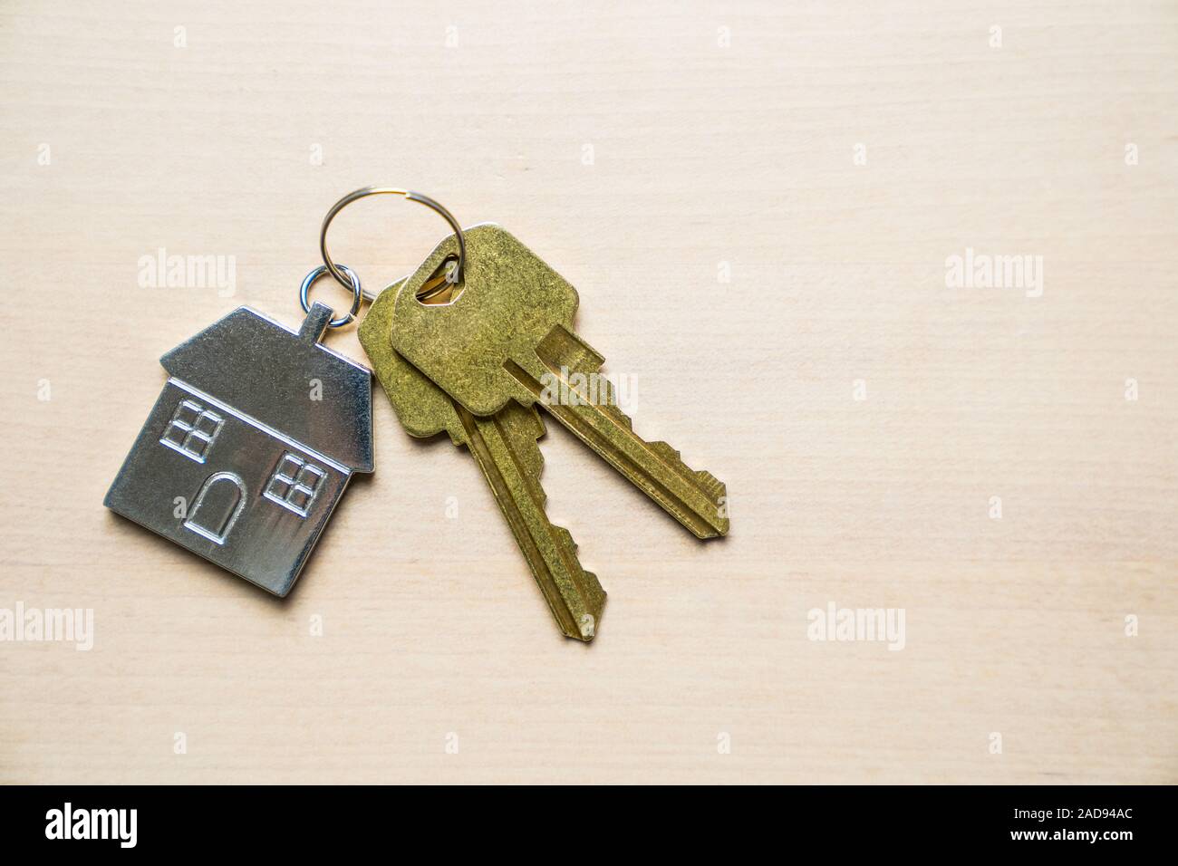 House keys and keychain on wooden background Stock Photo - Alamy