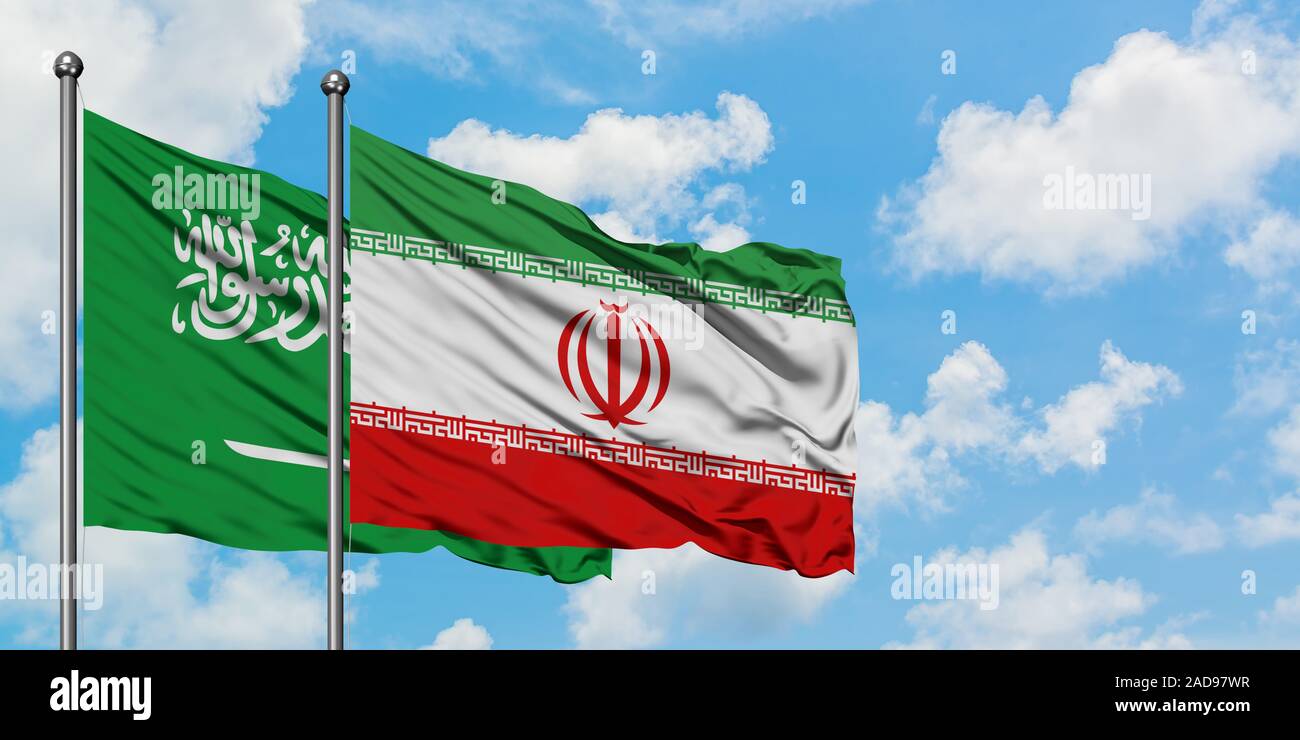 Saudi Arabia and Iran flag waving in the wind against white cloudy blue ...
