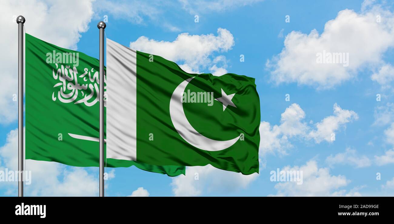 Saudi Arabia and Pakistan flag waving in the wind against white cloudy ...