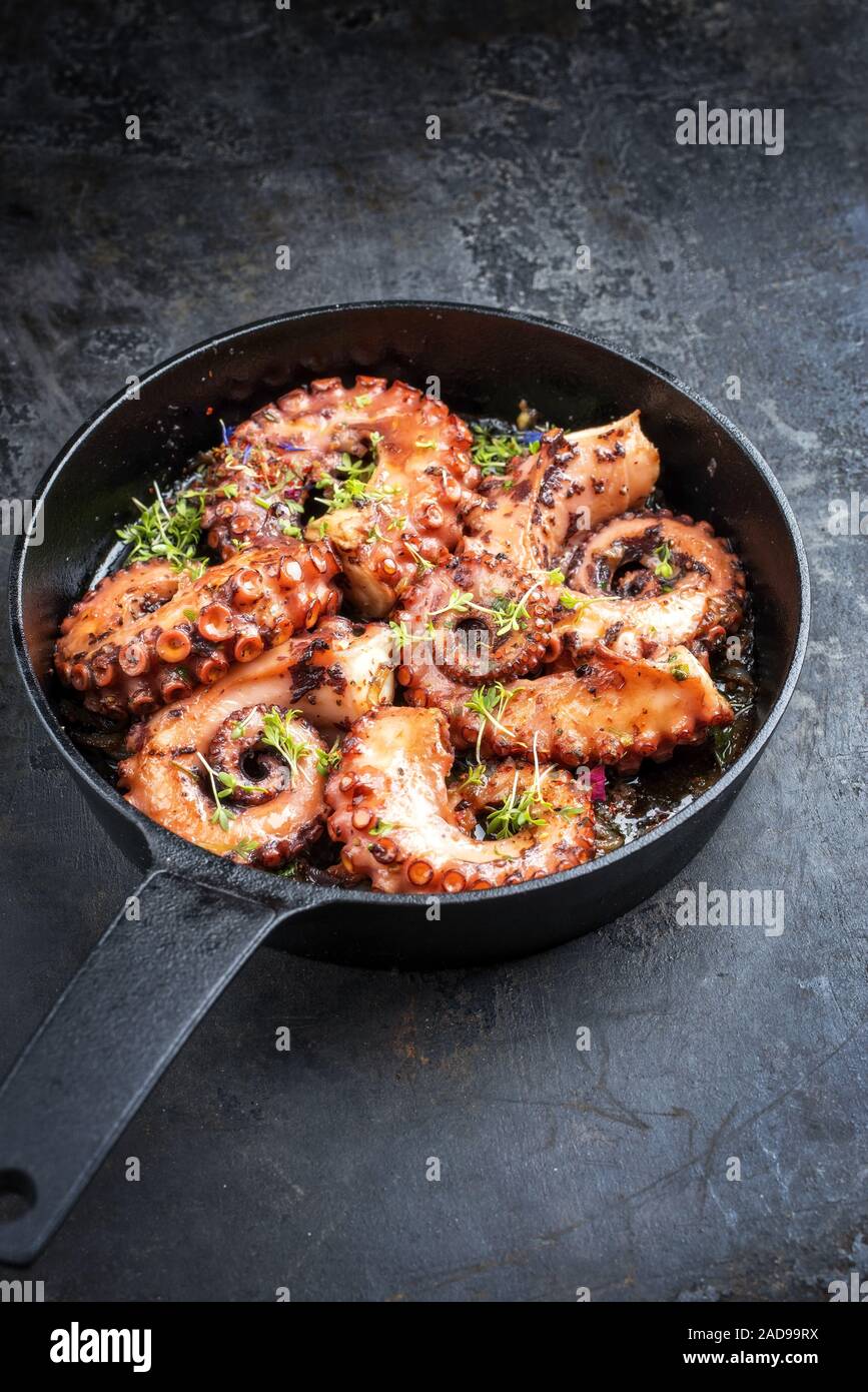 Traditional Spanish octopus braised cooked with tomatoes and herbs in ...