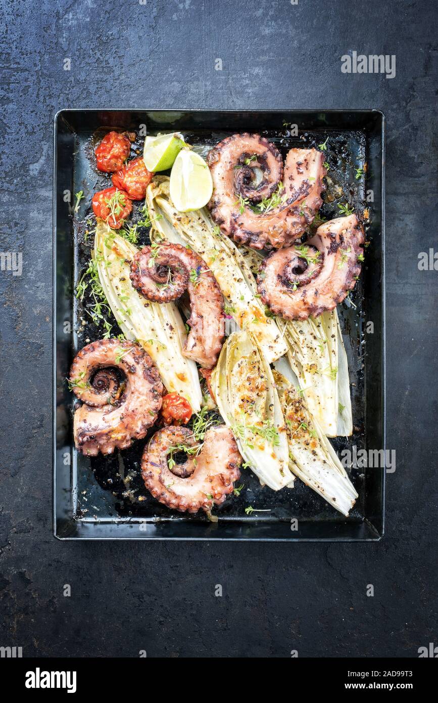 Traditional French octopus braised cooked with chicory and tomatoes in ...