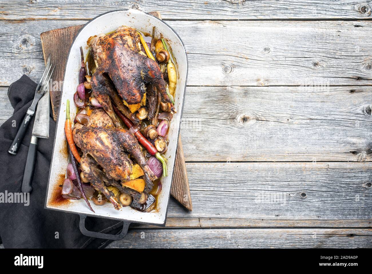 Traditional barbecue pheasant with vegetable and game sauce as top view ...