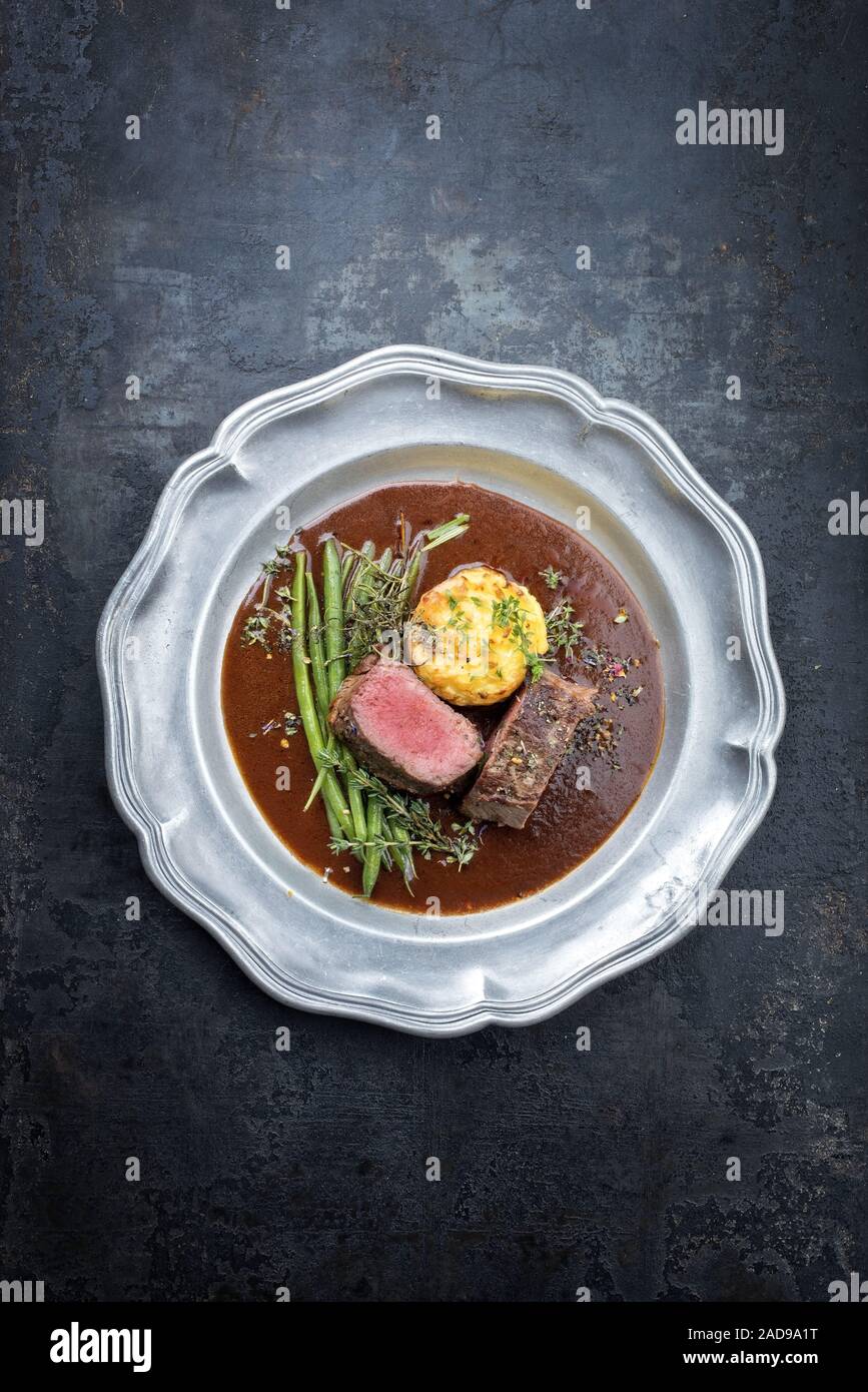 Traditional barbecue aged venison backstrap roast with green beans ...