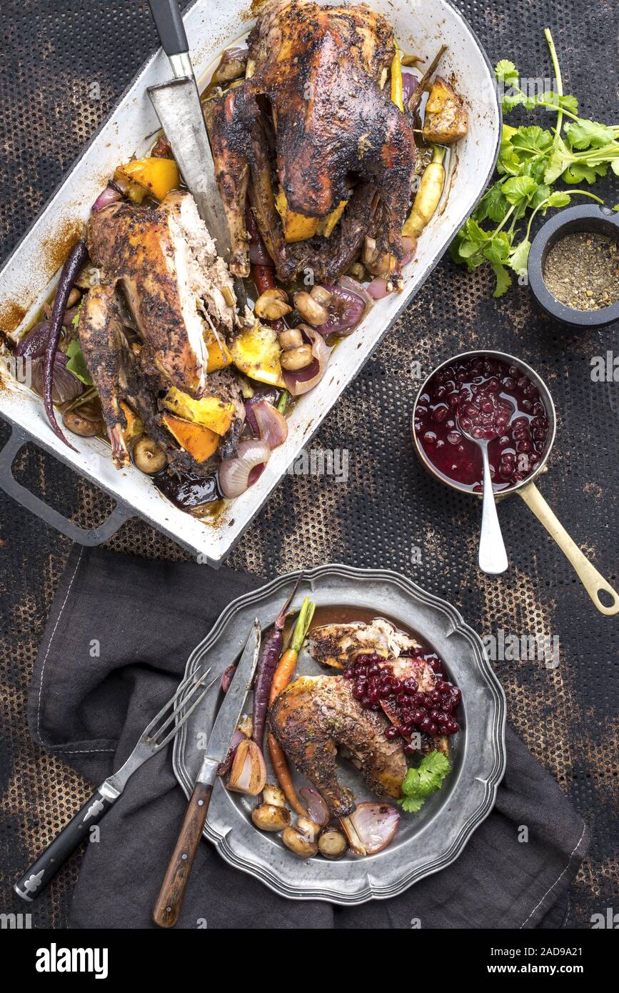 Traditional barbecue pheasant with vegetable and cranberry sauce as top ...