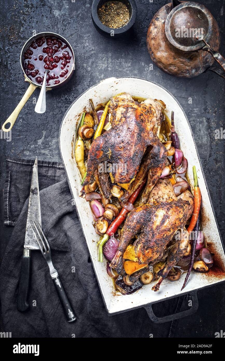 Traditional barbecue pheasant with vegetable and cranberry sauce as top ...