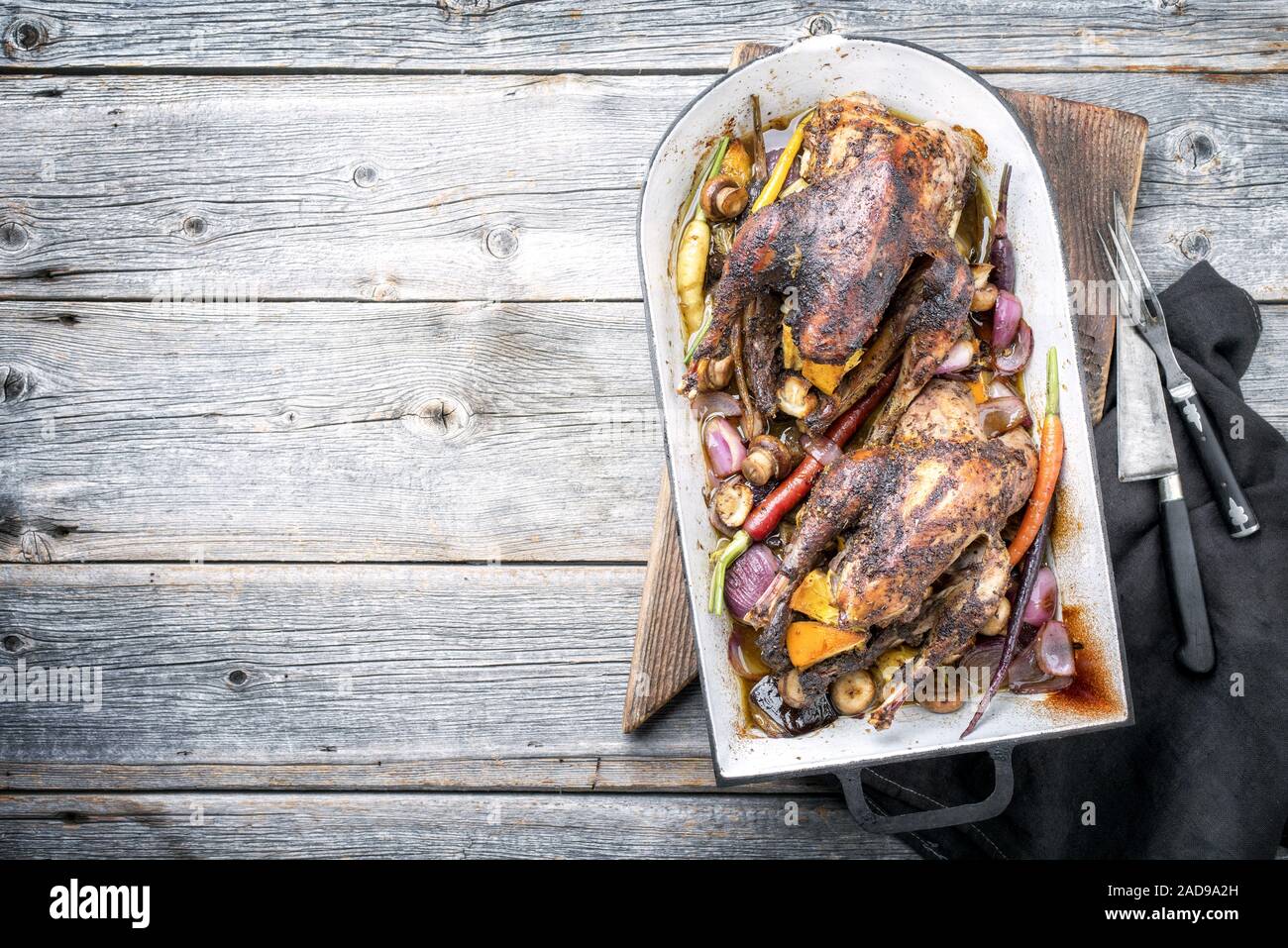 Traditional barbecue pheasant with vegetable and game sauce as top view ...