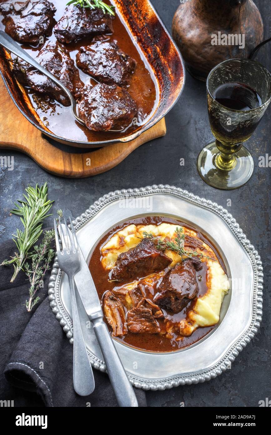 Traditional German braised veal cheeks in brown sauce with mashed ...
