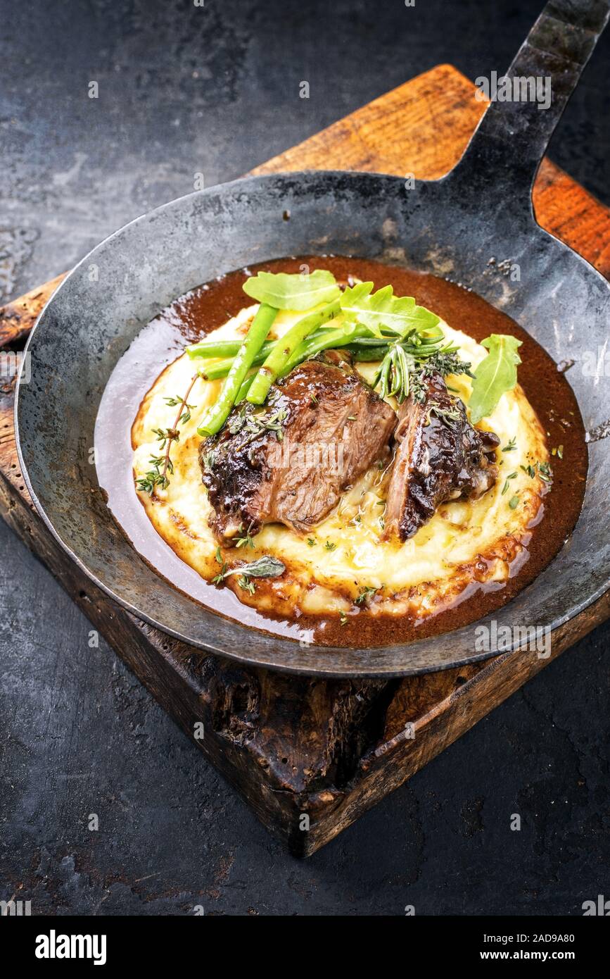 Traditional German braised veal cheeks in brown sauce with mashed ...
