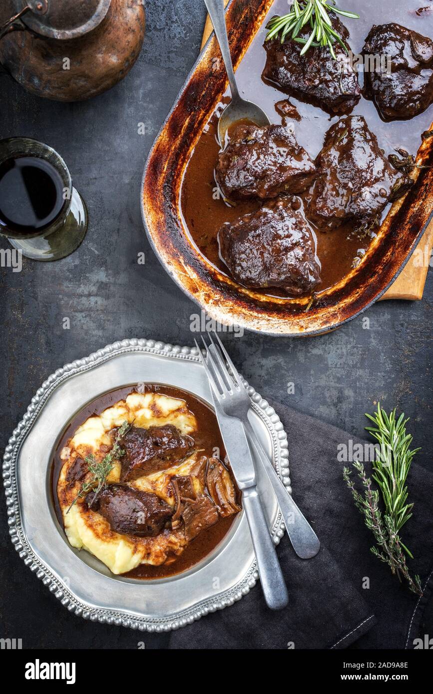 Traditional German braised veal cheeks in brown sauce with mashed ...