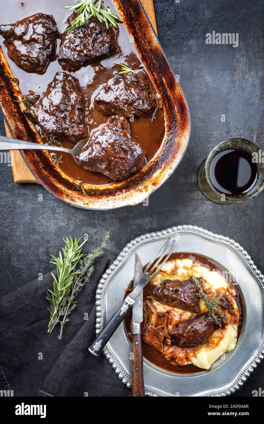 Traditional German braised veal cheeks in brown sauce with mashed ...