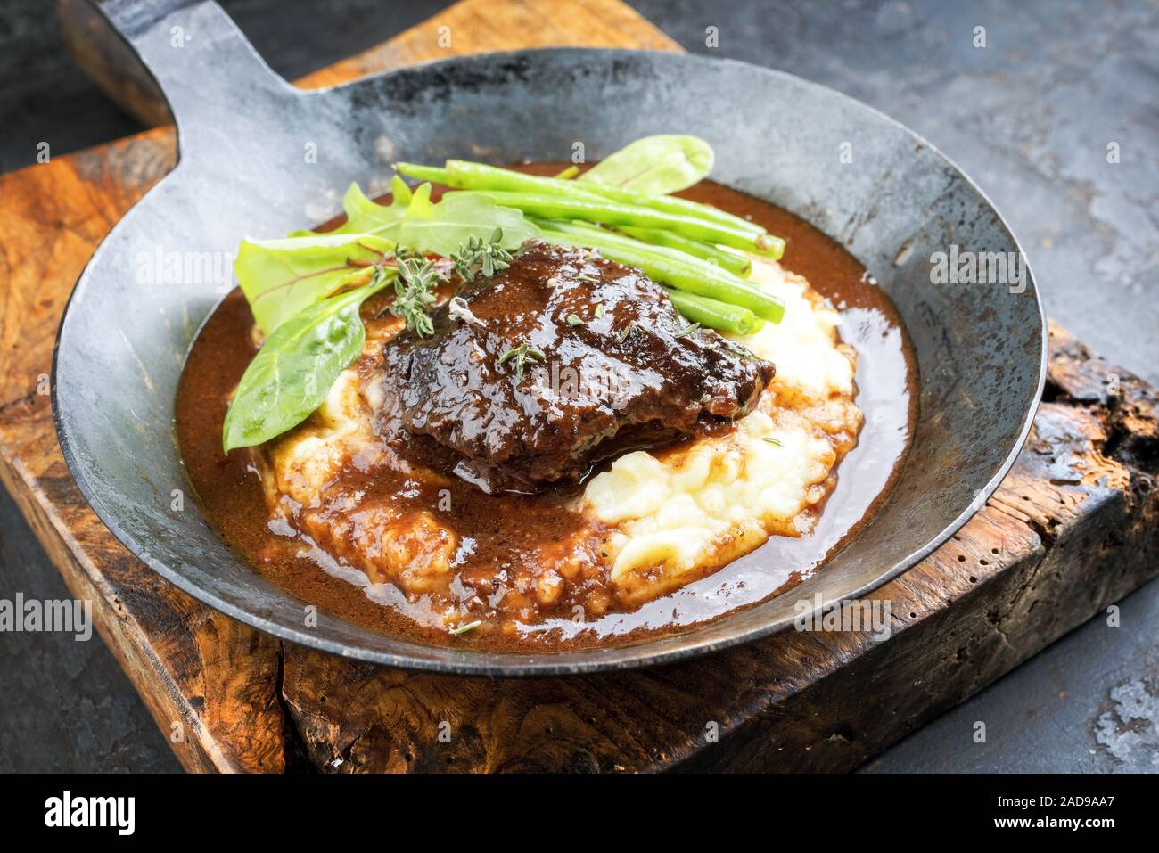 Traditional German braised veal cheeks in brown sauce with mashed ...