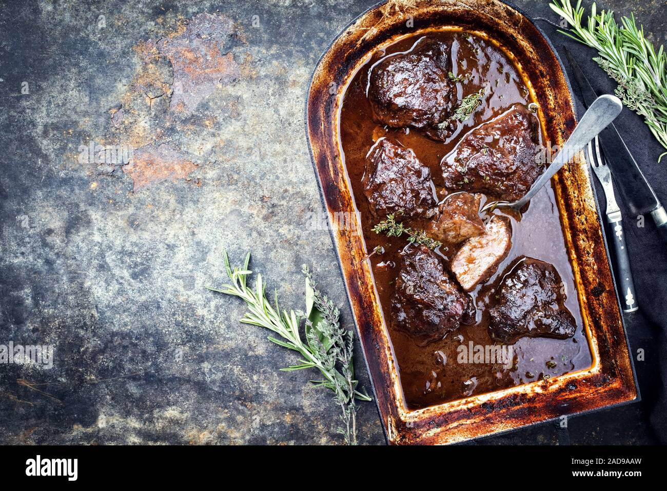 Traditional German braised veal cheeks in brown red wine sauce with ...