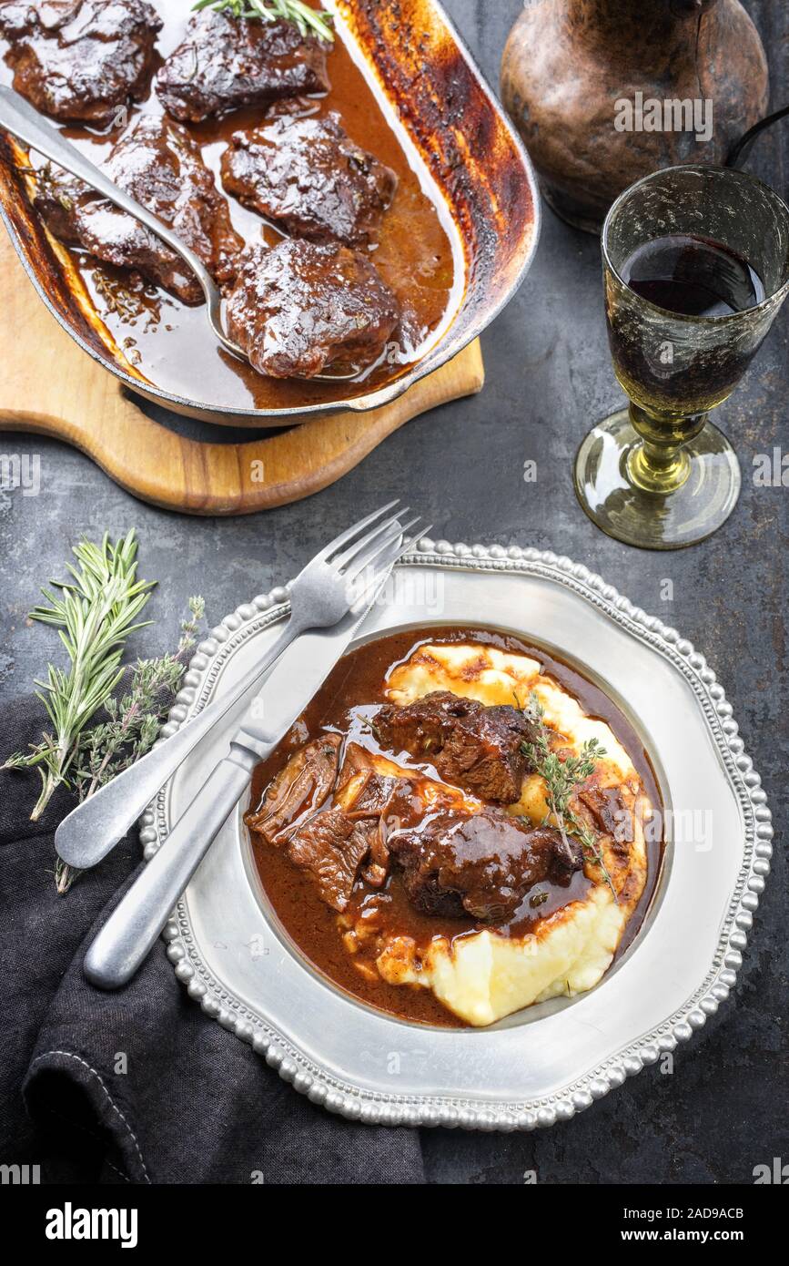Traditional German braised veal cheeks in brown sauce with mashed ...