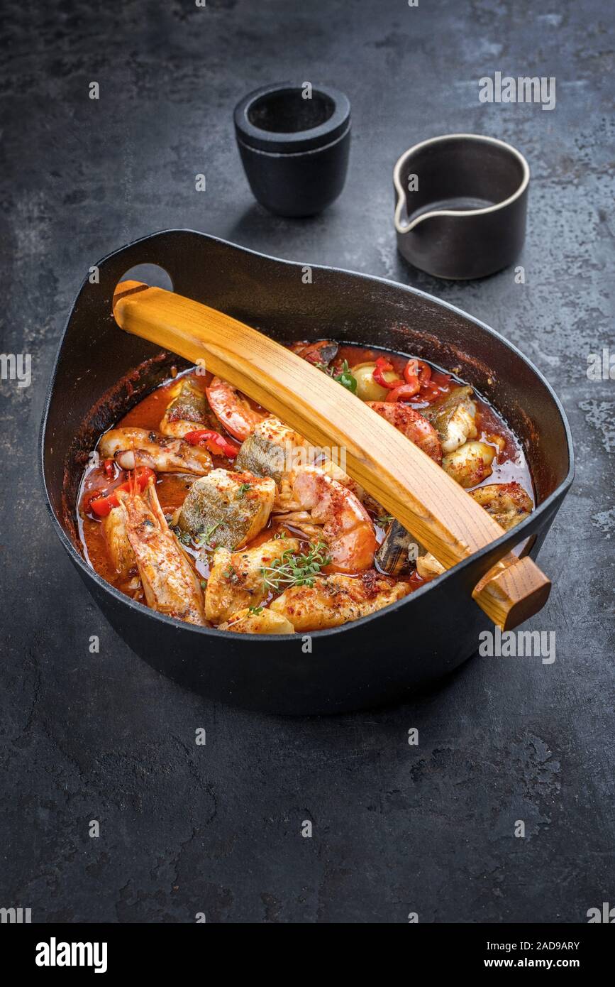 Traditional Asian fish stew with prawns Stock Photo - Alamy