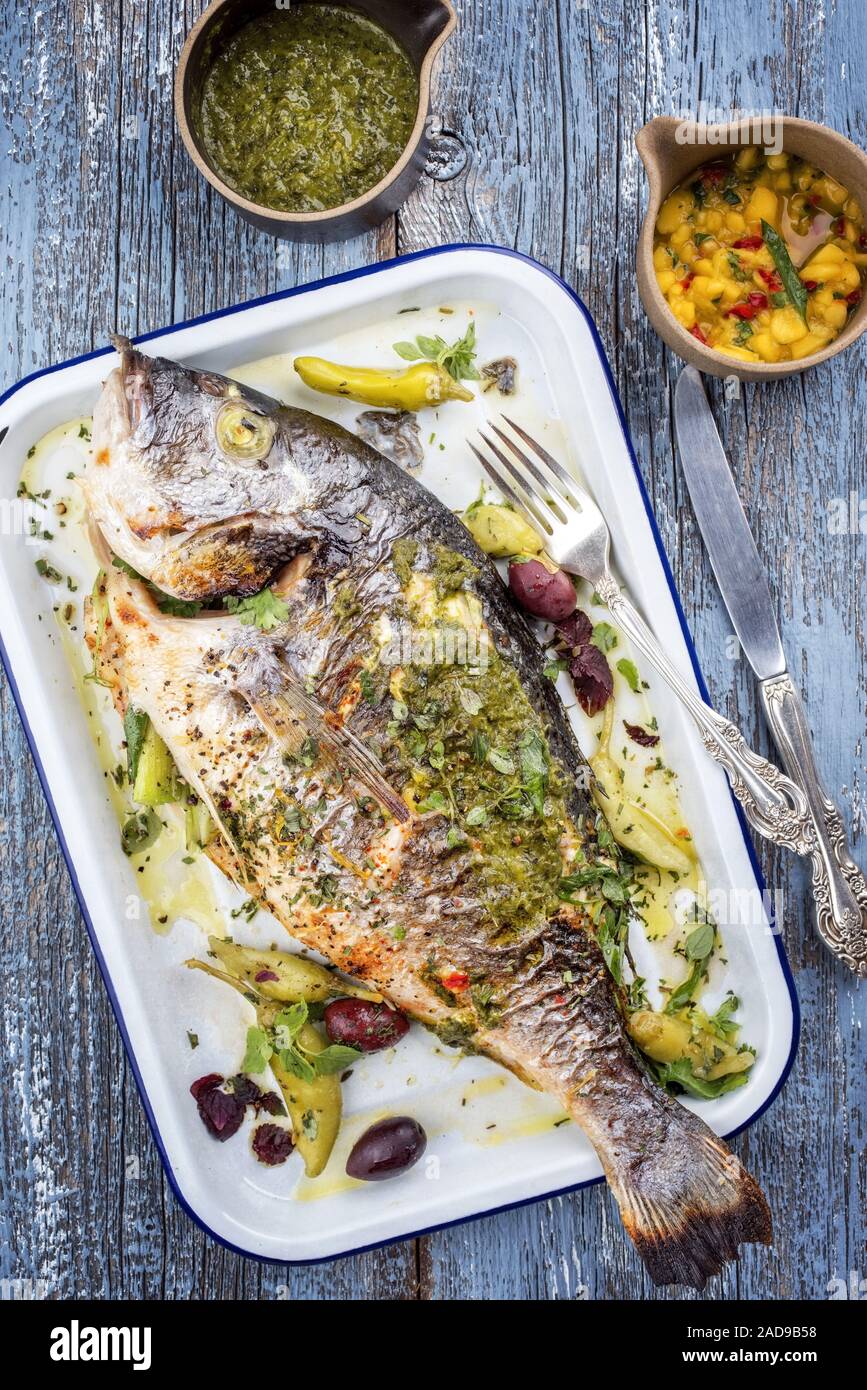 Fresh barbecue gilthead seabream with mango chutney and chimichurri as ...