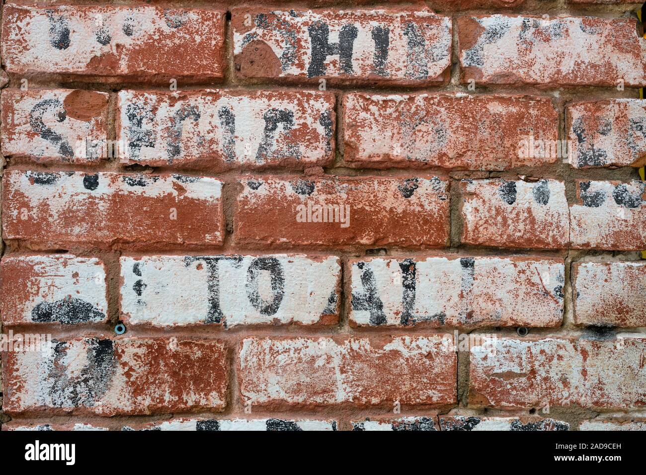 Brick wall with words Stock Photo - Alamy