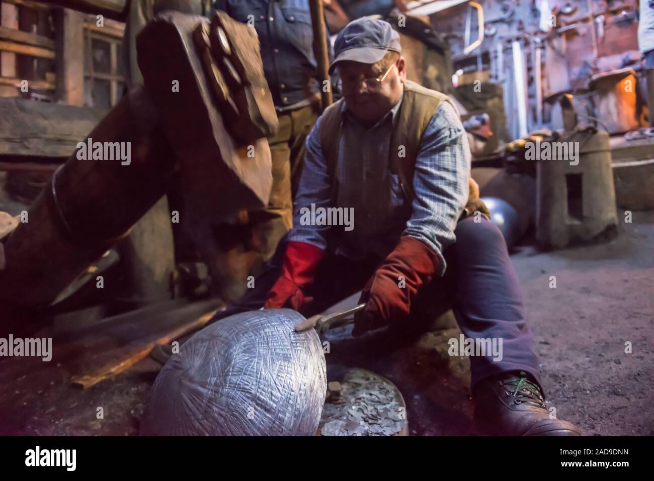 blacksmith workers using mechanical hammer at workshop Stock Photo - Alamy