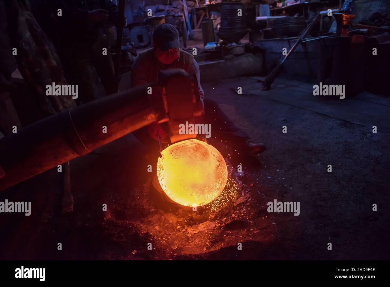 blacksmith workers using mechanical hammer at workshop Stock Photo - Alamy