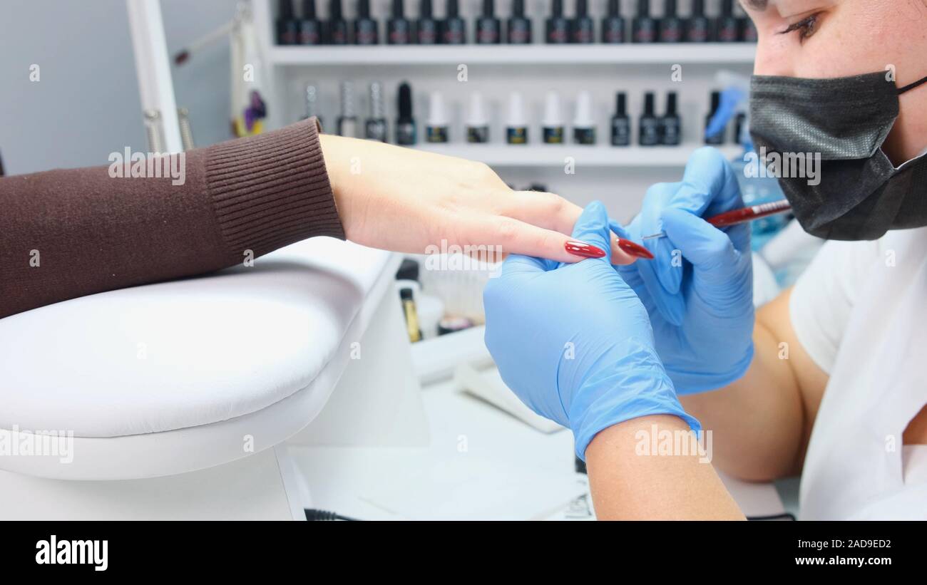 Manicurist drawing on nail close hi-res stock photography and images ...