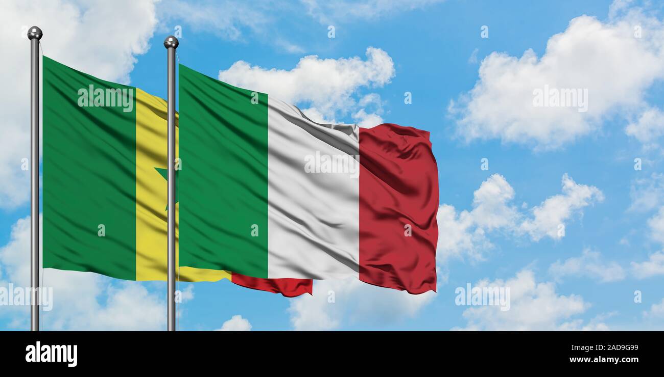 Senegal and Italy flag waving in the wind against white cloudy blue sky ...