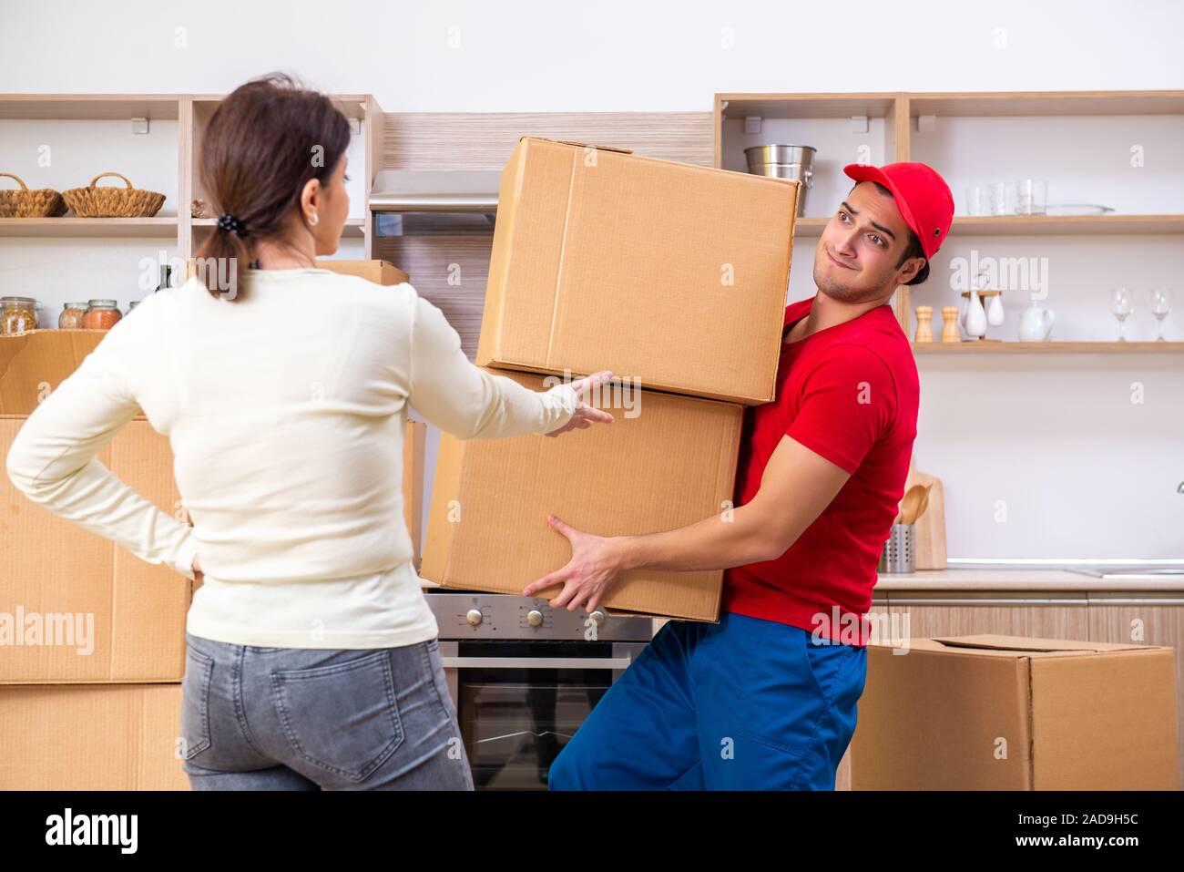 Young male contractor and female customer in moving concept Stock Photo ...
