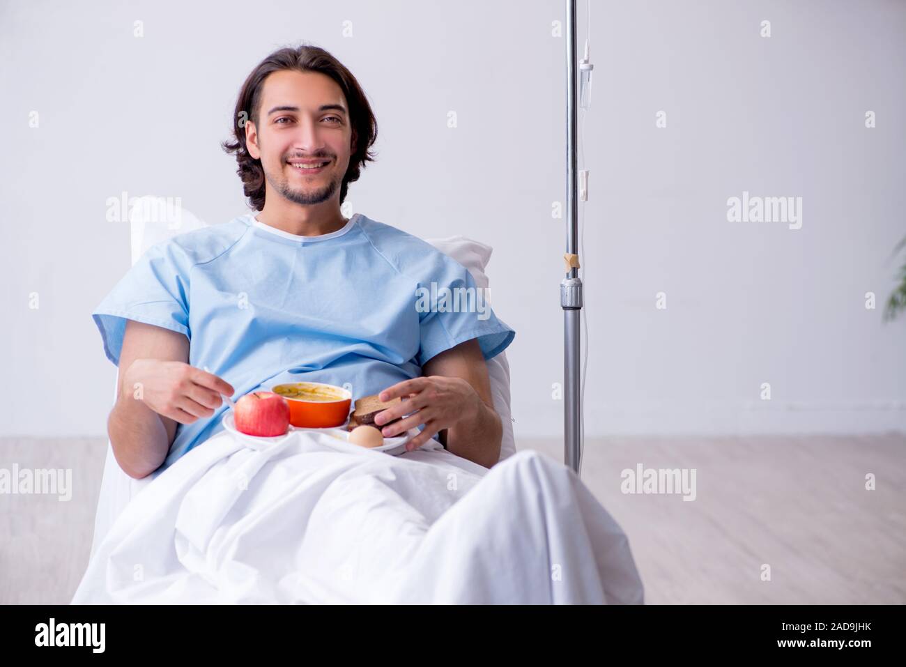 Male patient eating food in the hospital Stock Photo - Alamy