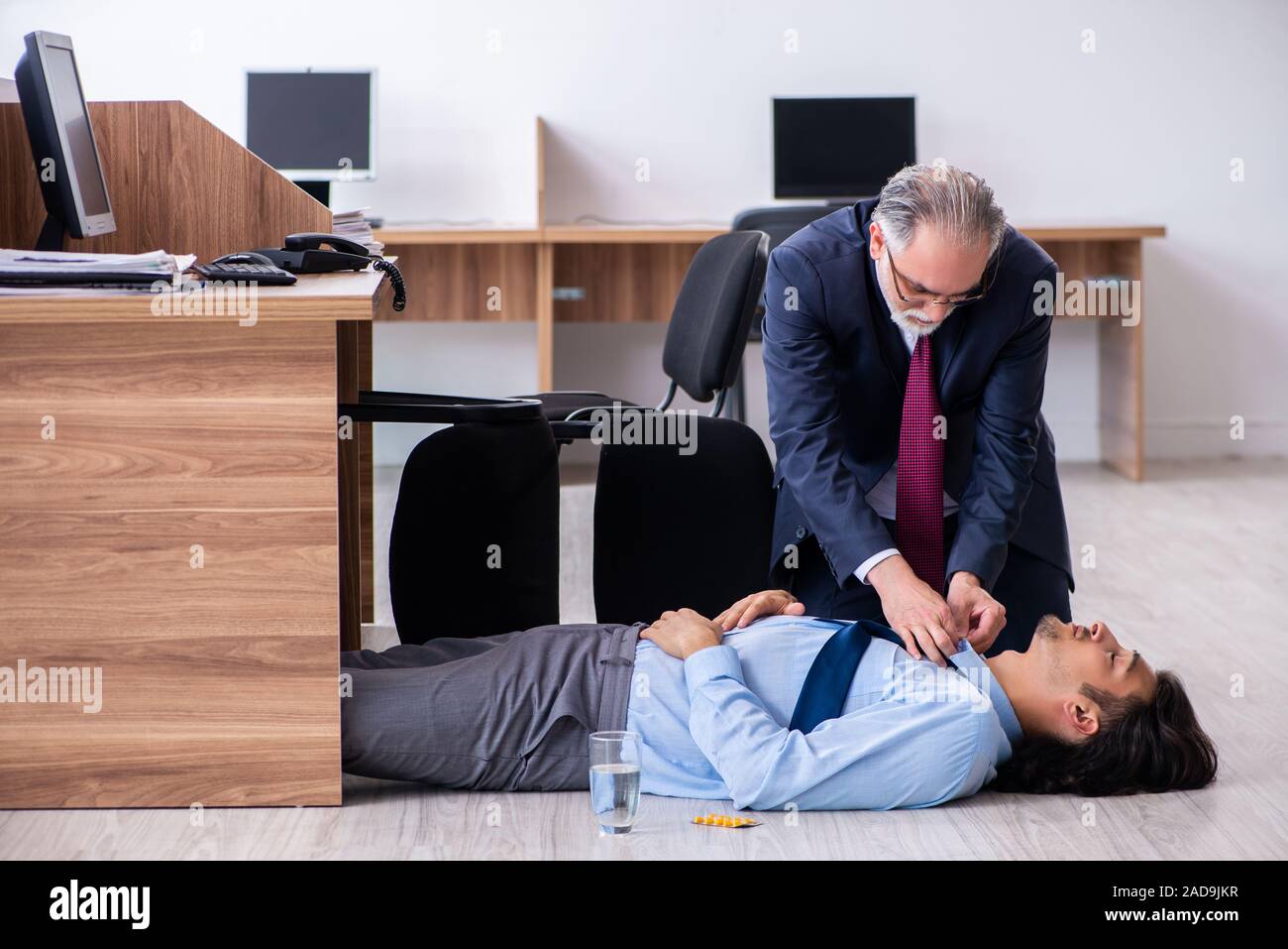 Male employee suffering from heart attack in the office Stock Photo - Alamy