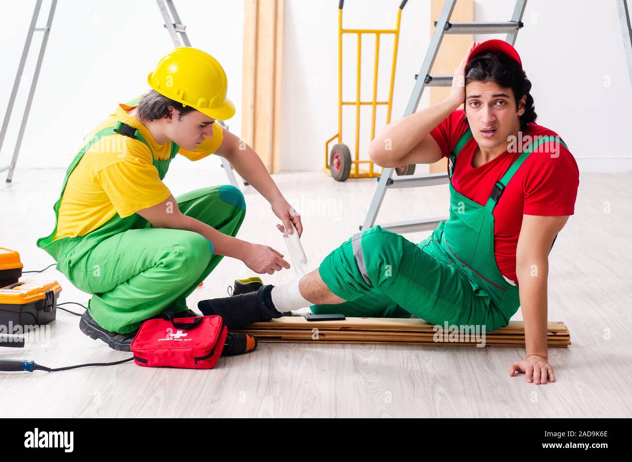 Injured worker and his workmate Stock Photo - Alamy
