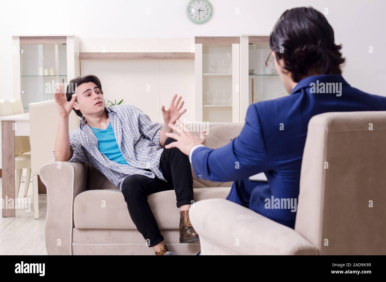 Young male patient discussing with psychologist personal problem Stock ...