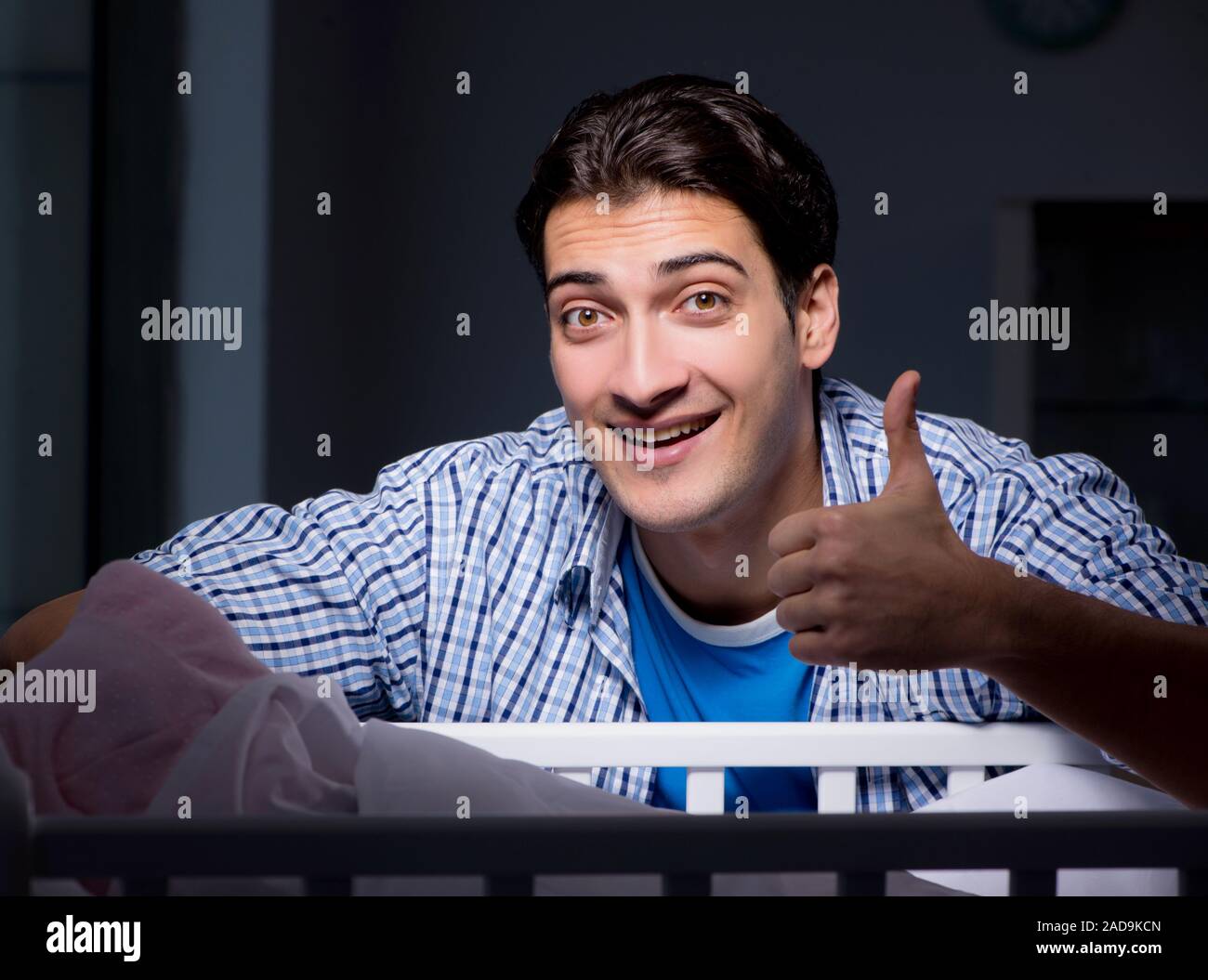 Happy dad looking after newborn baby at night Stock Photo - Alamy