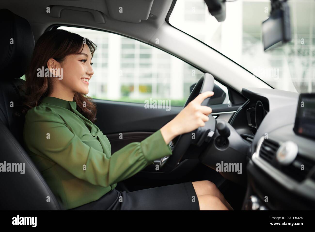 Young beautiful woman driving her car Stock Photo - Alamy